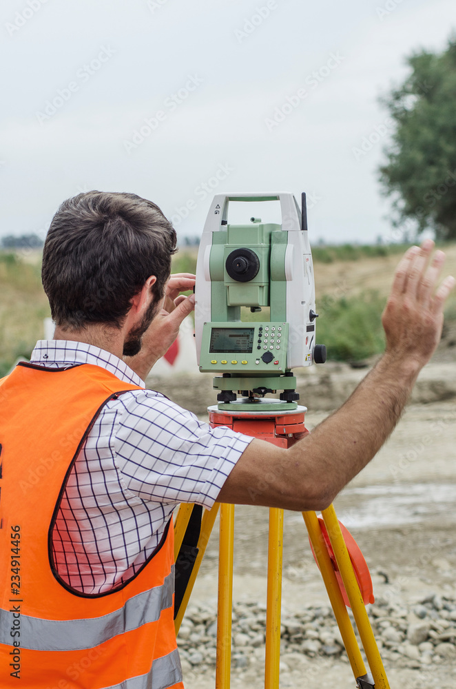 Civil engineer land survey with tacheometer or theodolite equipment ...