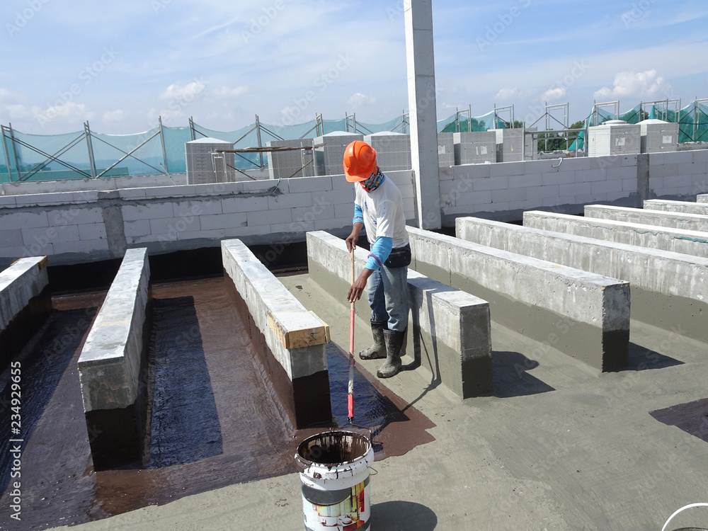 Waterproofing membrane applied by construction workers on top of ...