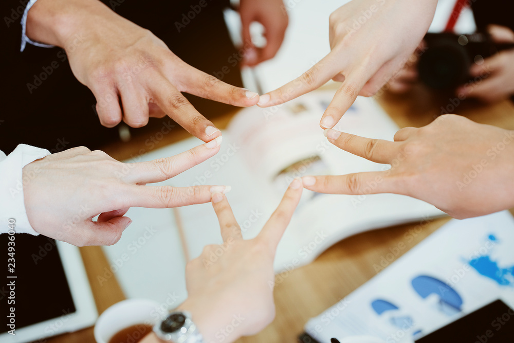 Many business people join hands to demonstrate harmony. The ...
