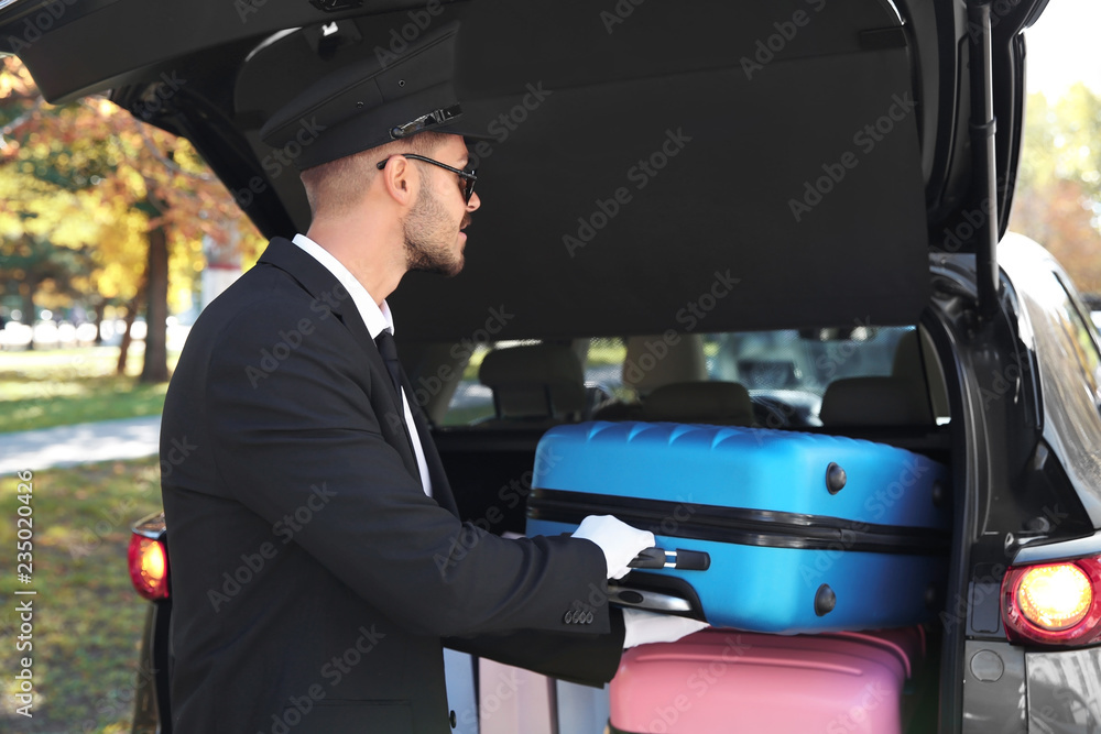 Young driver loading suitcases into car trunk outdoors Stock Photo ...