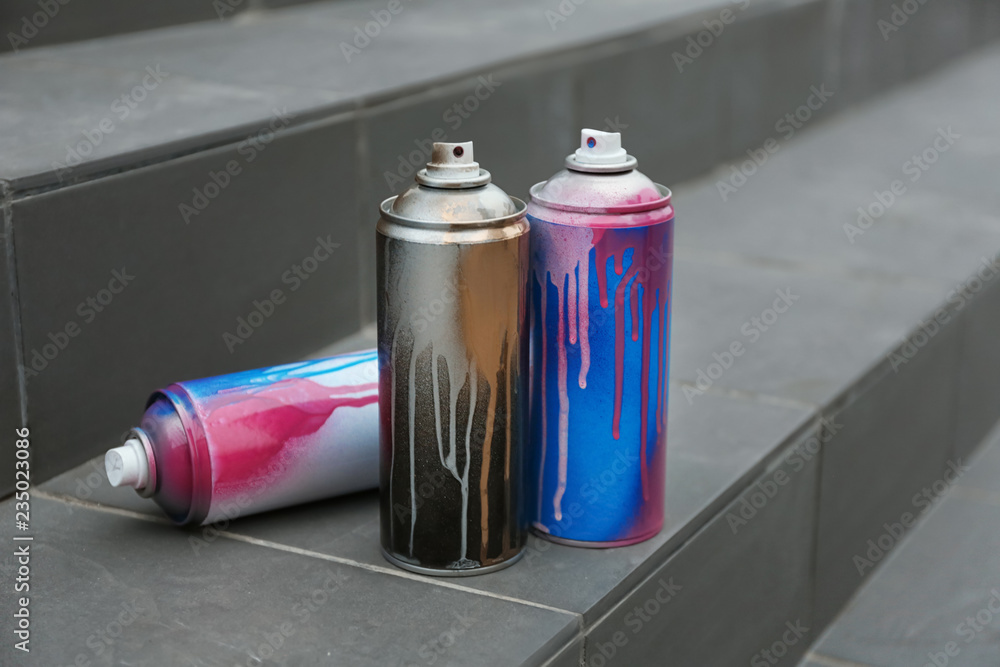 Used cans of spray paint on stairs Stock Photo | Adobe Stock