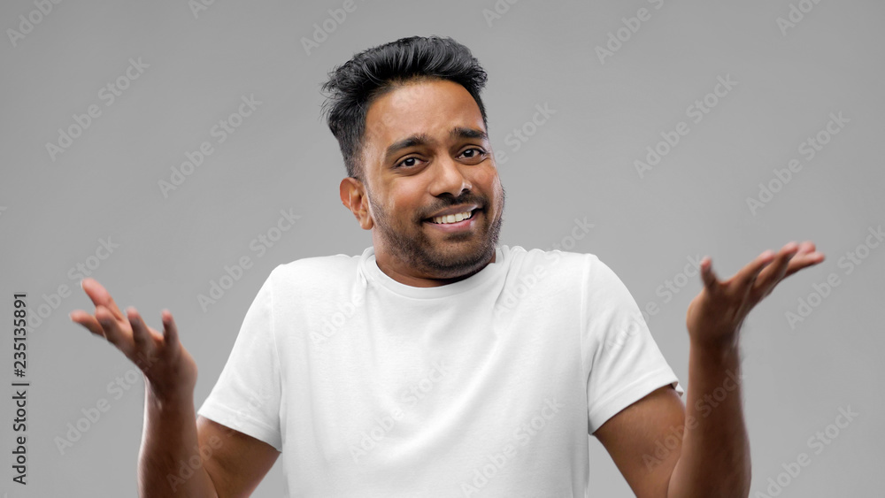 people, emotion and expression concept - confused indian man shrugging ...