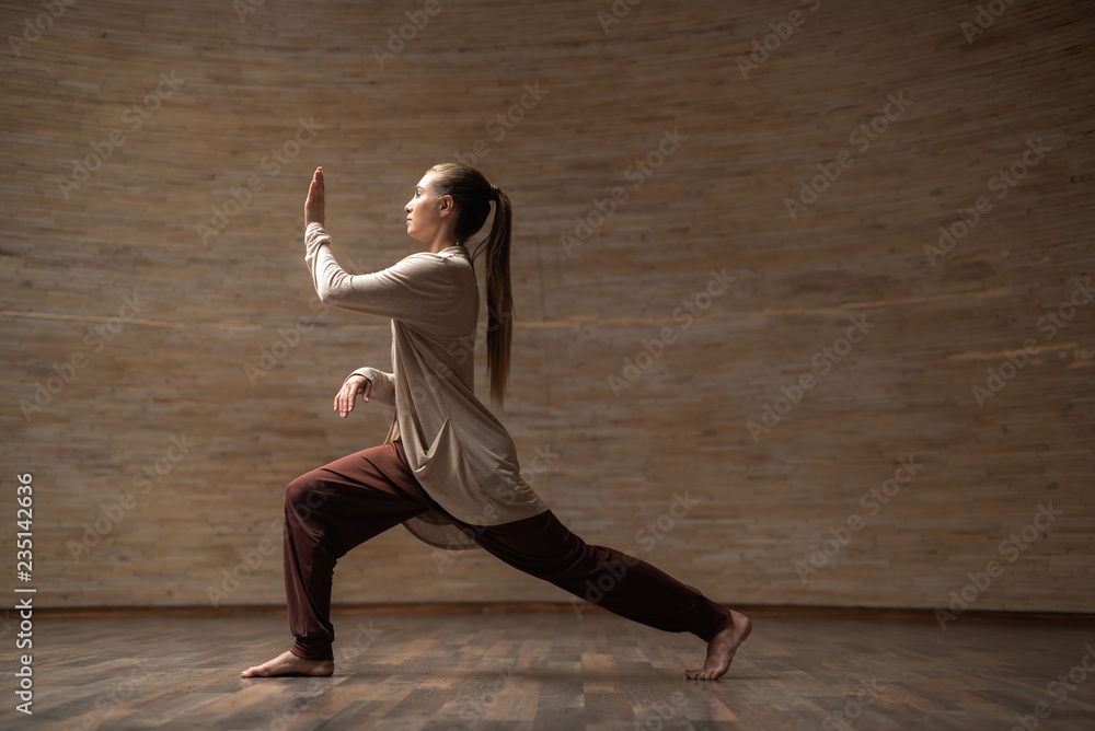 Calm long haired lady placing hands in front of her face and bending ...