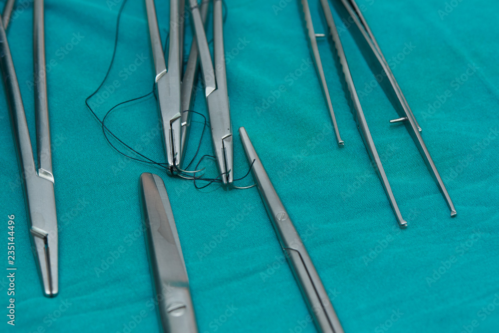 Needle holders with needles and sutures, surgical forceps and scissors ...