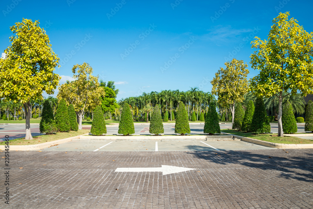 Empty space in city park outdoor concrete parking lot area with blue ...