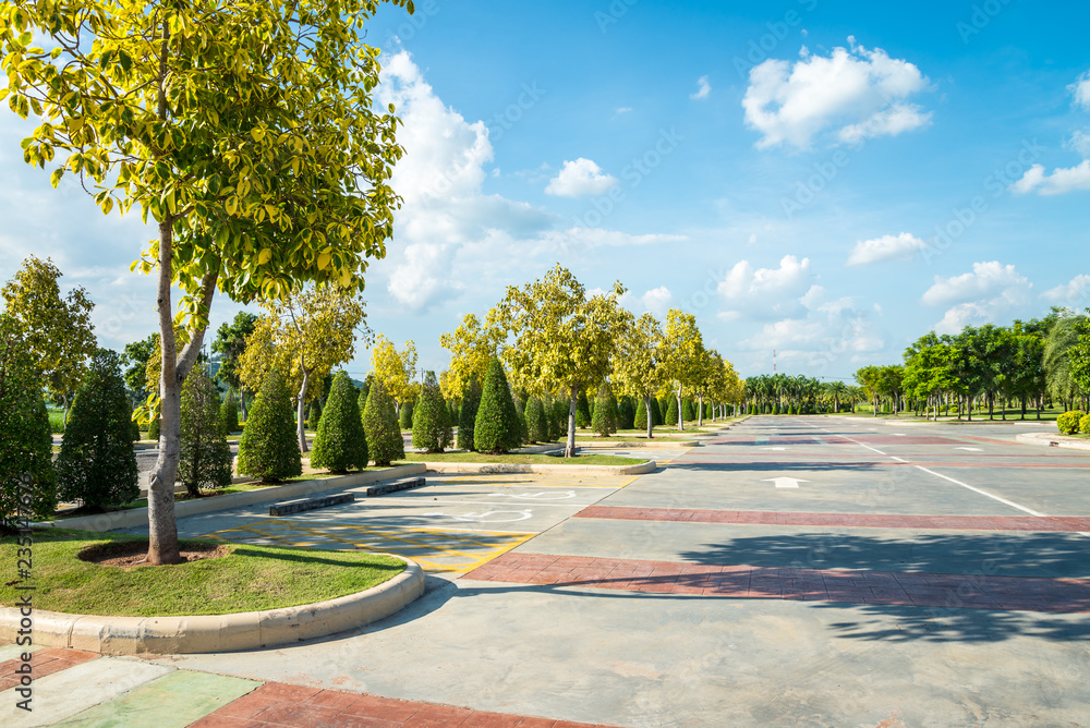 Empty space in city park outdoor concrete parking lot area with blue ...
