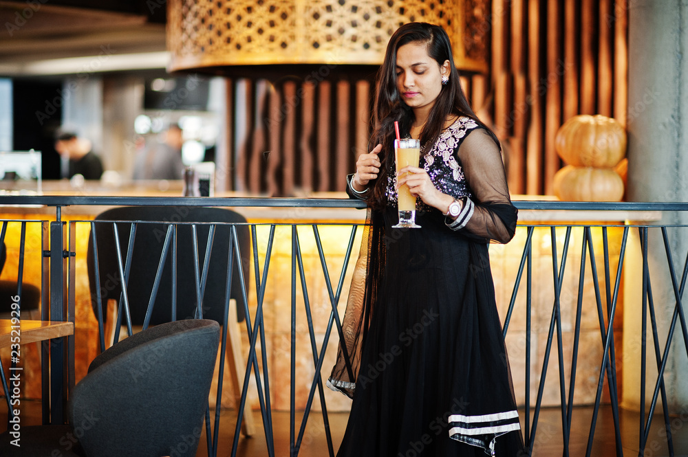 Pretty indian girl in black saree dress posed at restaurant with orange ...