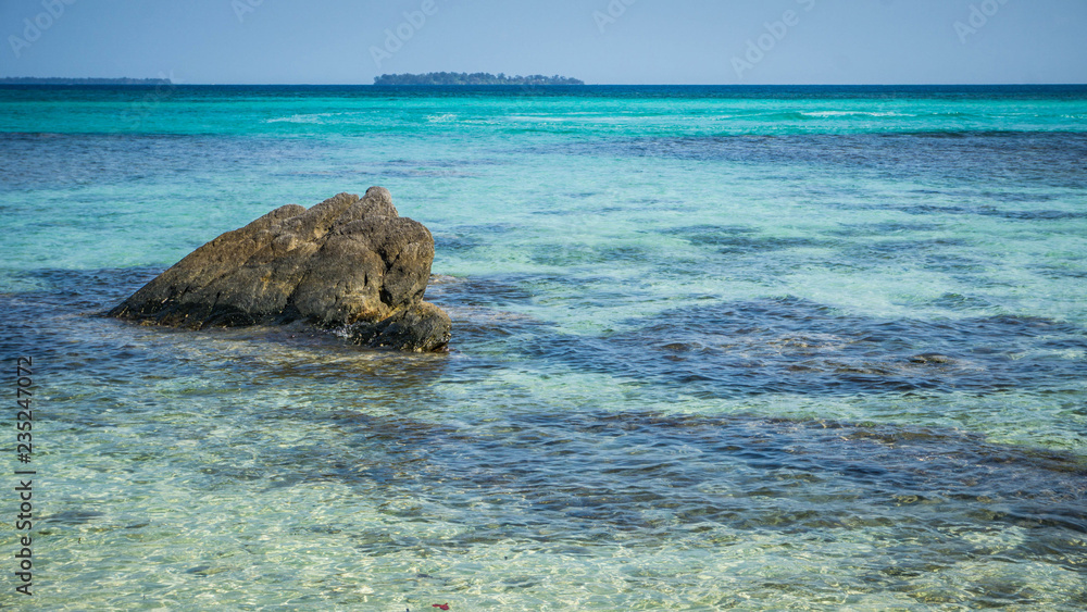 stone on the narrow beach sea with blue and green turqoise water on ...