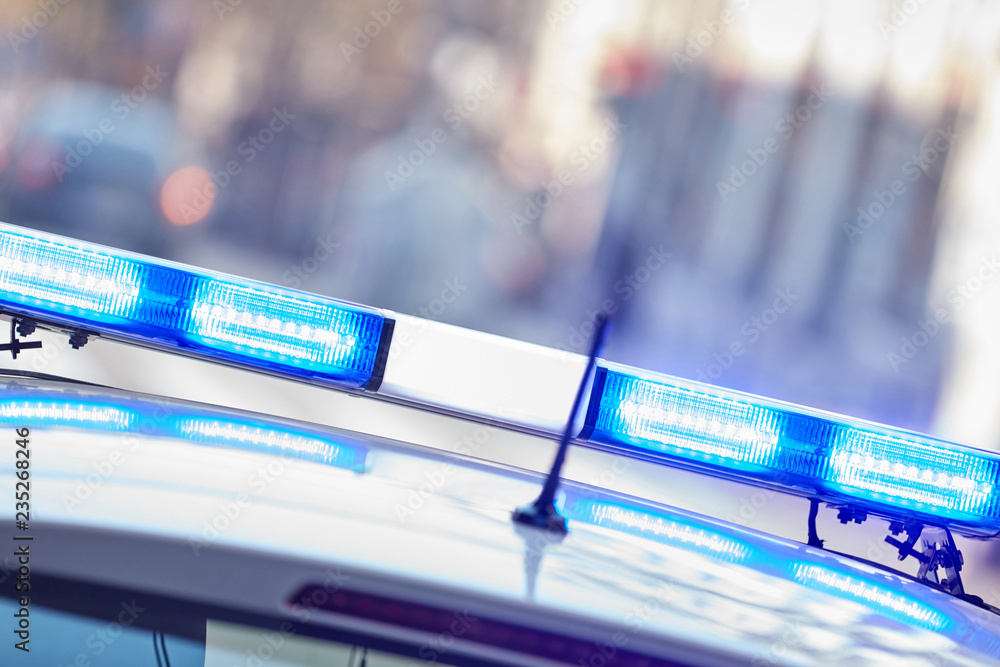 Police car with blue lights on the crime scene in traffic / urban ...
