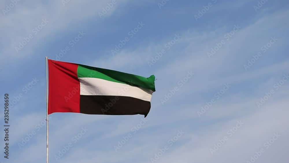 UAE flag waving in the sky, national symbol of UAE. UAE National Day ...