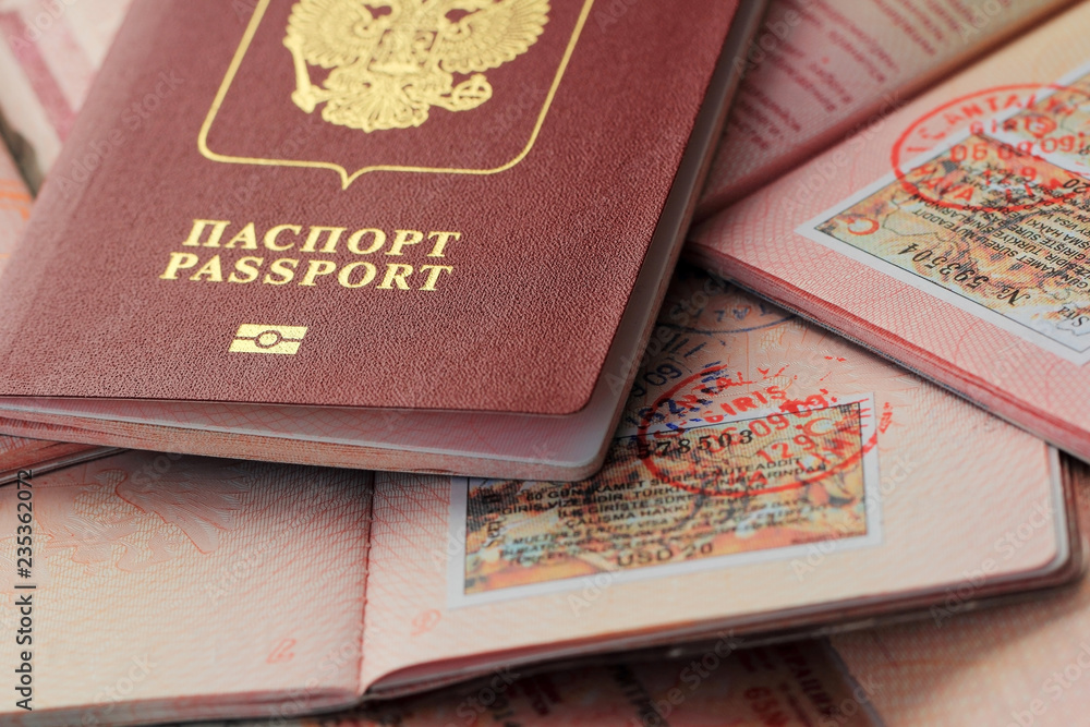 Russian passports and visa immigration stamps. Background of documents ...