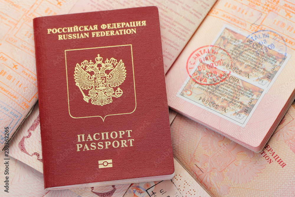 Russian passports and visa immigration stamps. Background of documents ...
