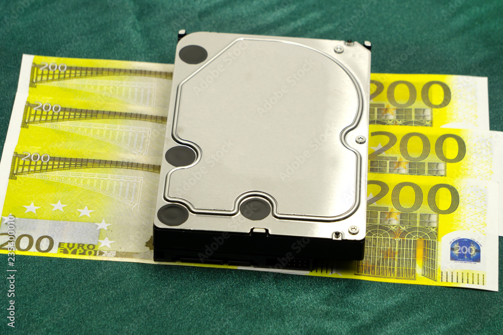 yellow 200 Euro and hard drive data disc . Stock Photo | Adobe Stock