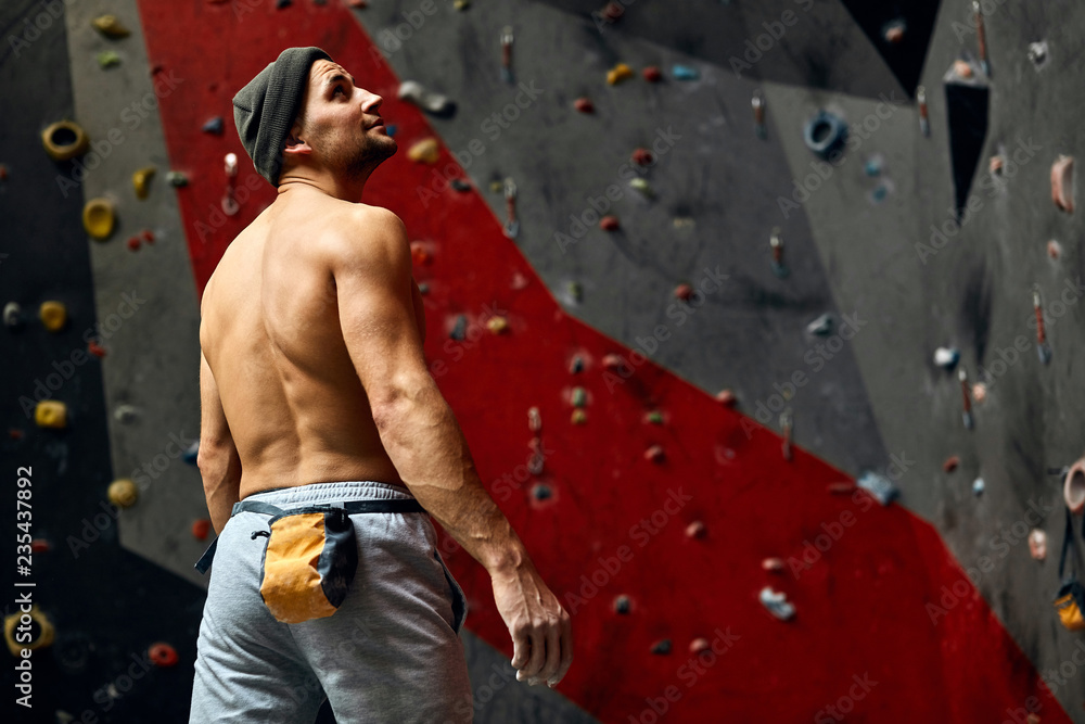 Rear view of athletic male climber with naked muscular perfect body ...