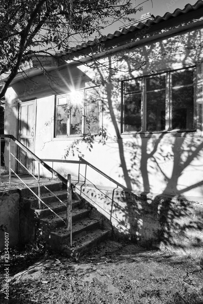 Old house with steps upstairs, window, shadows and lights. The ...