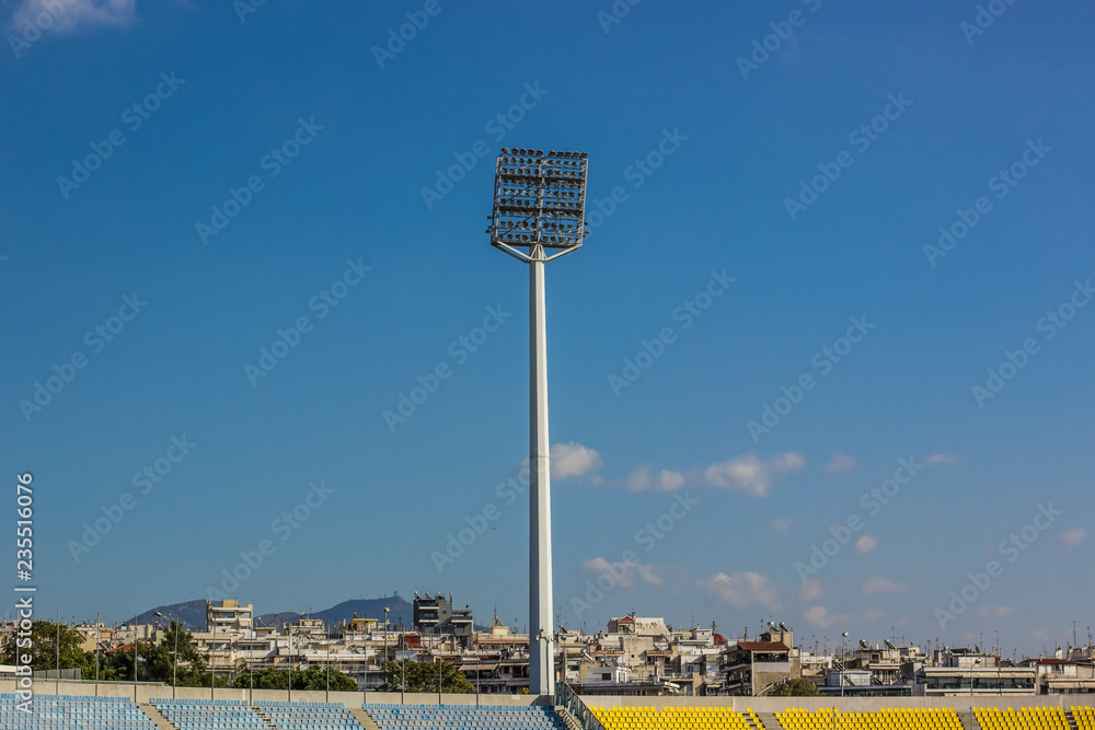 empty football stadium complex and led light projector in summer bright ...
