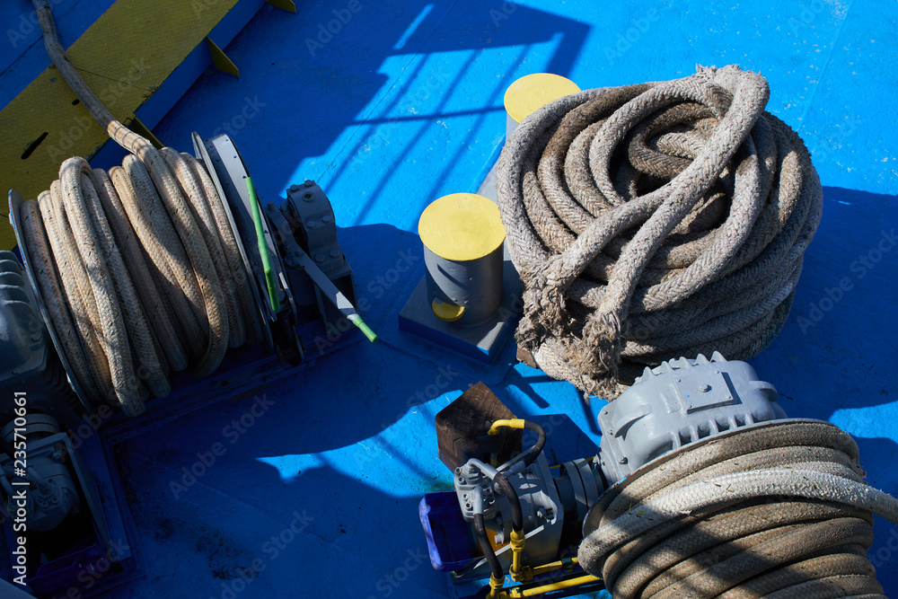 Mooring station with winches and wound up ropes on the foredeck of a ...