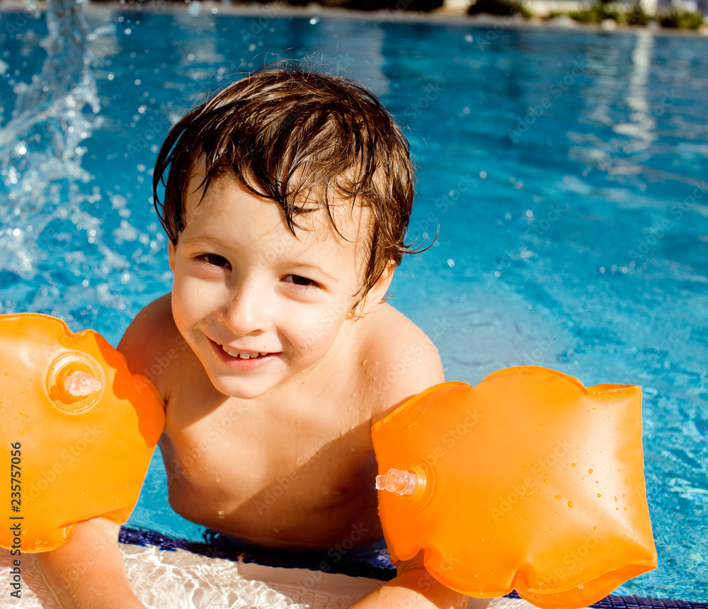 little cute boy in swimming pool wearing orange handcarves Stock Photo ...