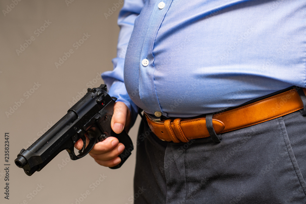 Big fat belly of a Japanese male in a blue shirt, holding a gun Stock ...