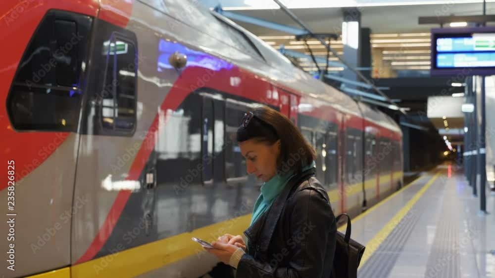 Underground modern railway station, a platform with girl looking at ...