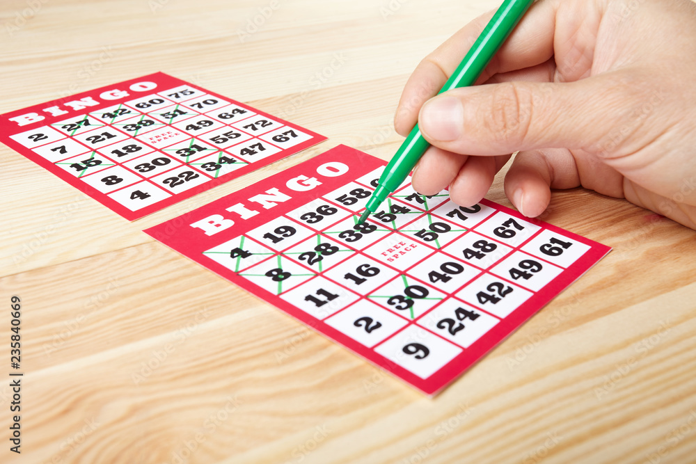 Hand marking bingo winning numbers. Stock Photo | Adobe Stock