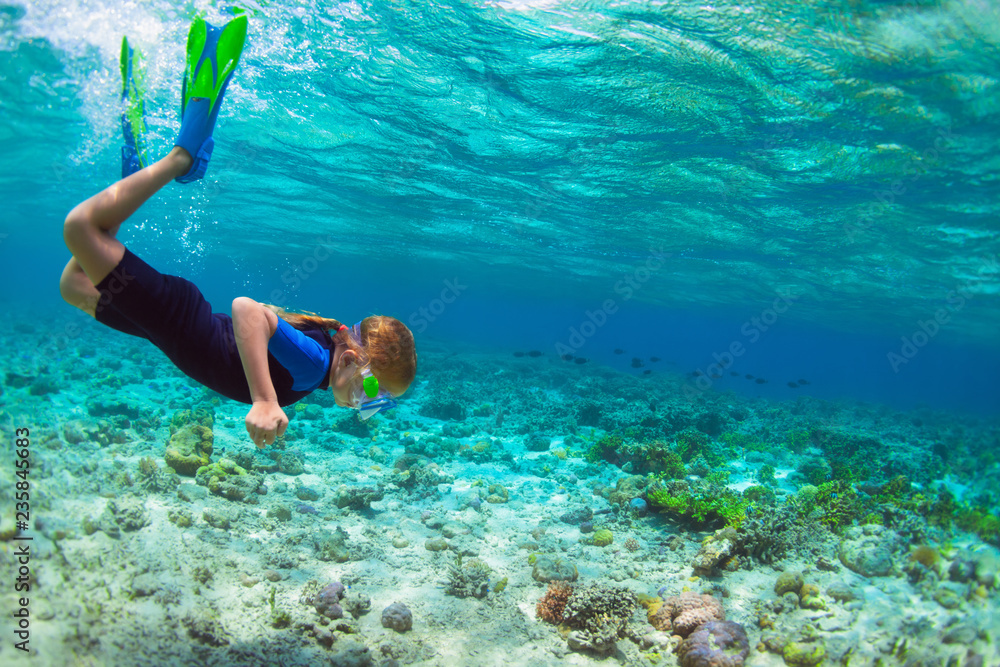 Happy little kid in snorkeling mask dive underwater with tropical ...