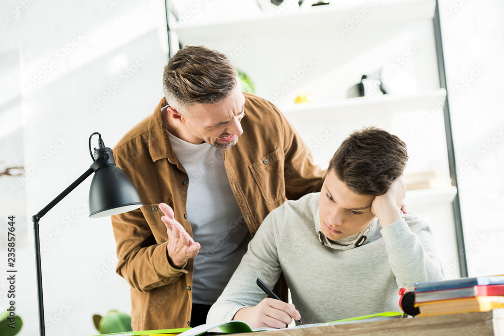 angry father yelling at teen son, boy covering ears Stock-Foto | Adobe ...
