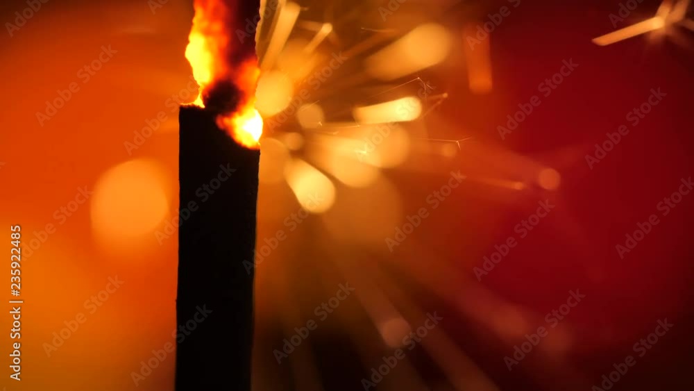 Vidéo Stock Sparkler Over Orange. Gun powder sparks shot against deep ...