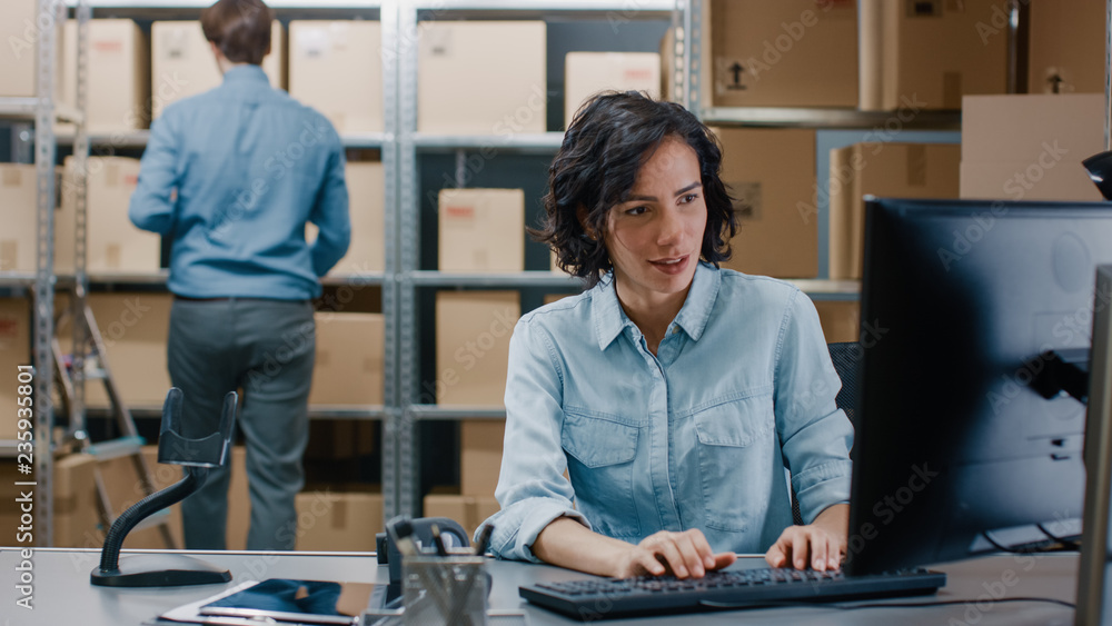 Female Inventory Manager Sitting at Her Desk and Using Personal ...