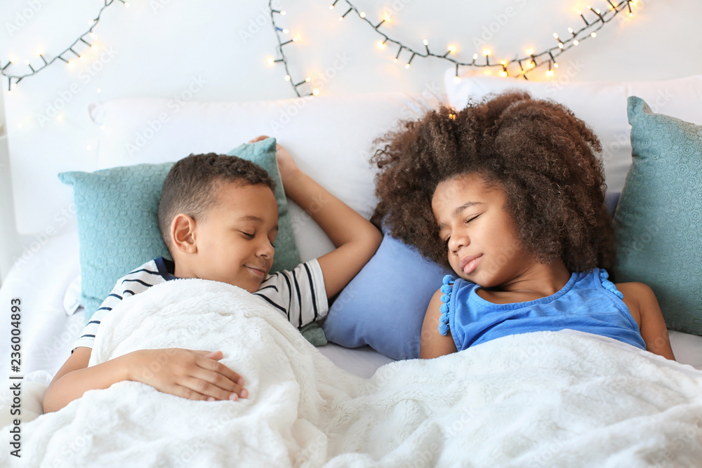 Cute African American children sleeping in bed. Family bedtime Stock ...