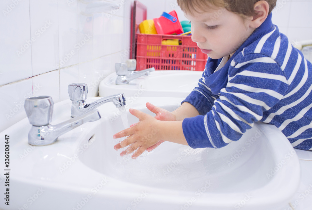 Child boy washing hands at adapted school sink Stock Photo | Adobe Stock