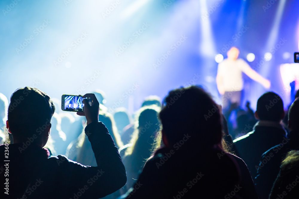 Concert crowd attending a concert, people silhouettes are visible ...