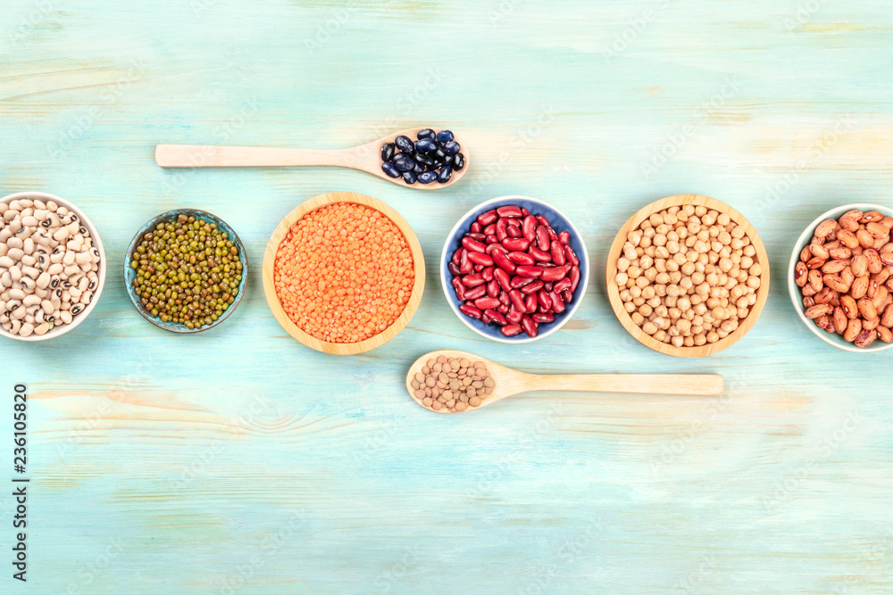 Various types of pulses, shot from above on a teal background with copy ...