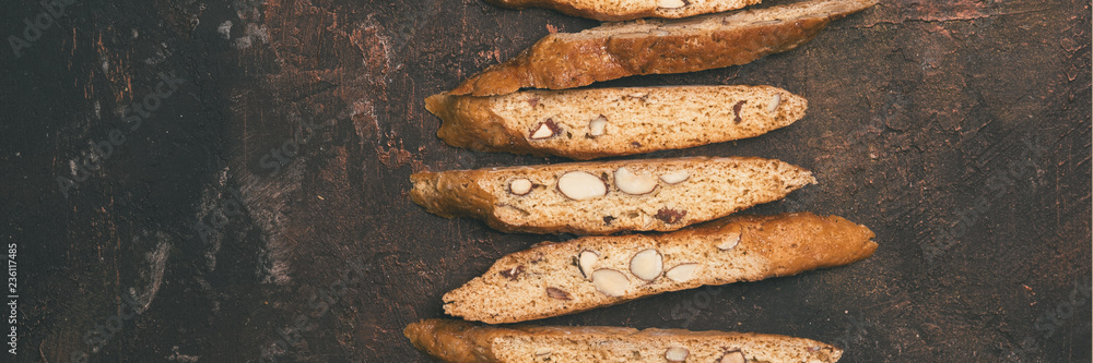 Biscotti - traditional Italian almond dessert on dark copper background ...