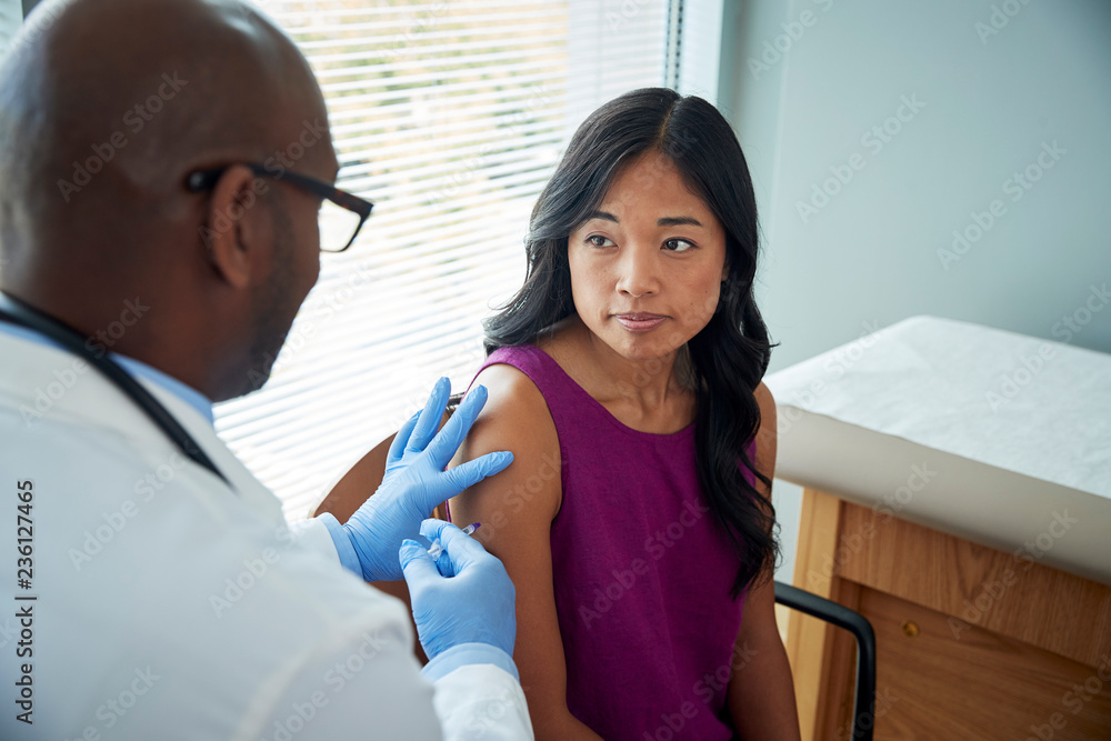 Female patient getting a shot at the doctor's office Stock Photo ...