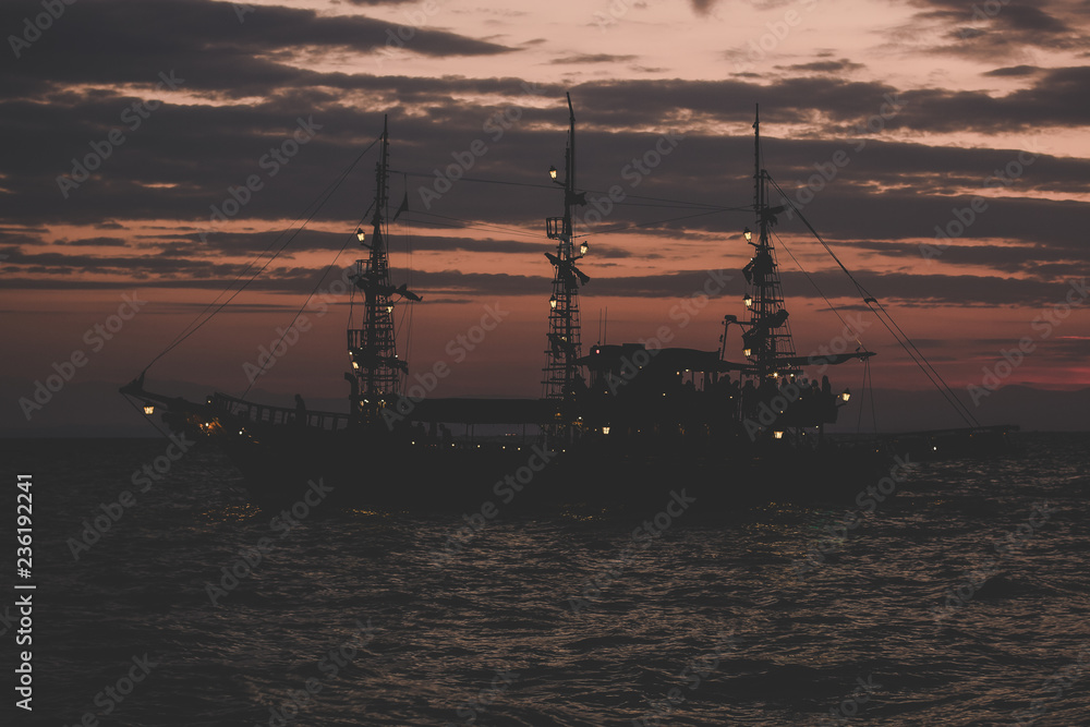 pirates concept of soft focus old vintage ship silhouette on sea water ...