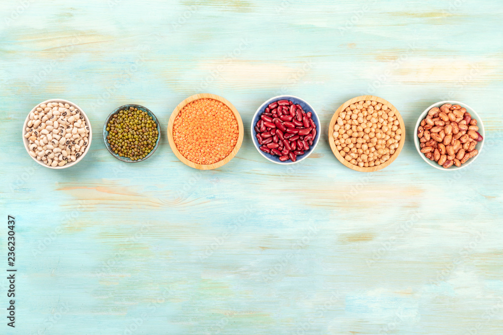 Various types of pulses, shot from above on a teal background with copy ...
