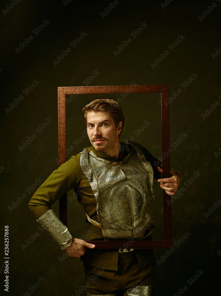 Medieval knight on dark studio background. Portrait in low key of ...
