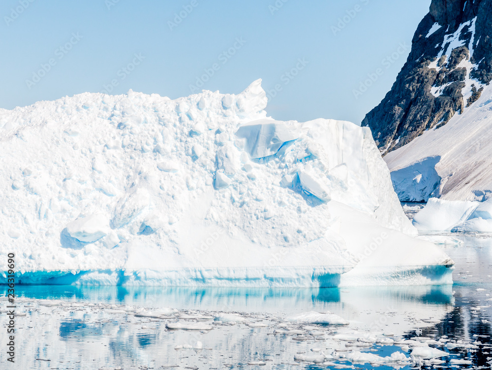 Iceberg with calving ice and snow floating in Errera Channel, Antarctic ...