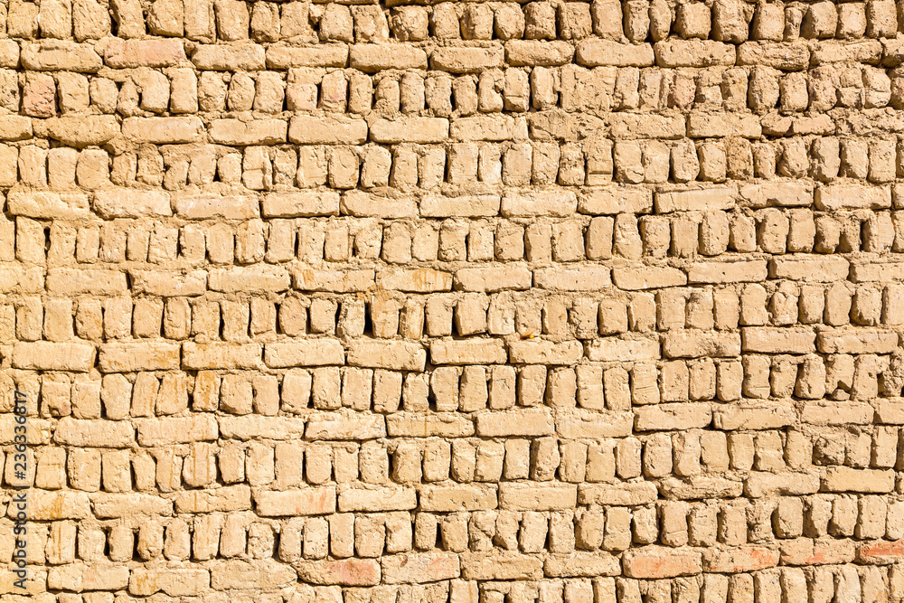 Ancient islamic Arabic muslim old town house wall built of yellow brown ...