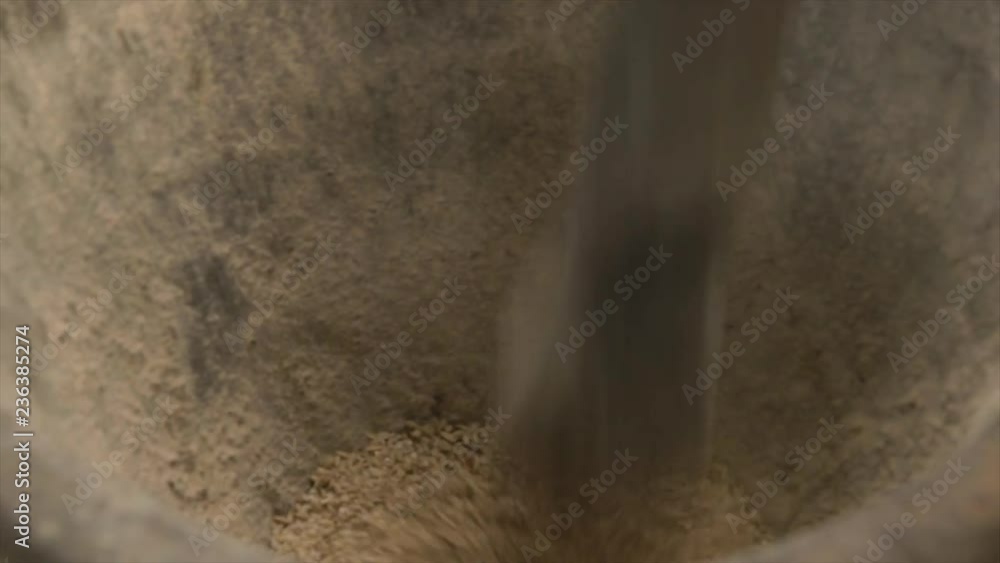 Extreme close up still shot of dried light- brown, small rice grains at ...