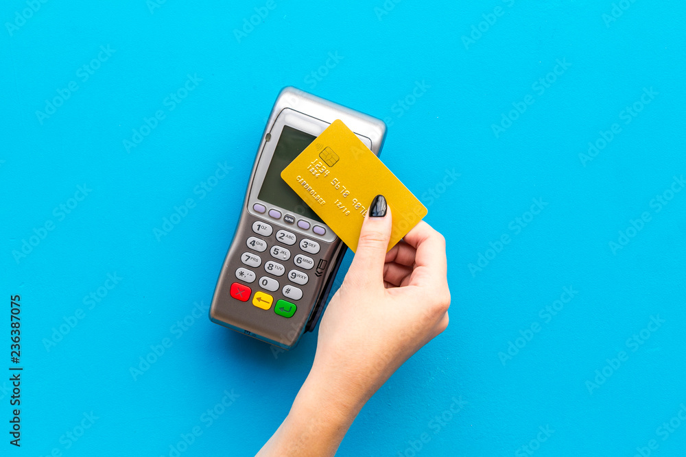 Pay by payment terminal. Paypass technology. Woman's hand hold credit ...