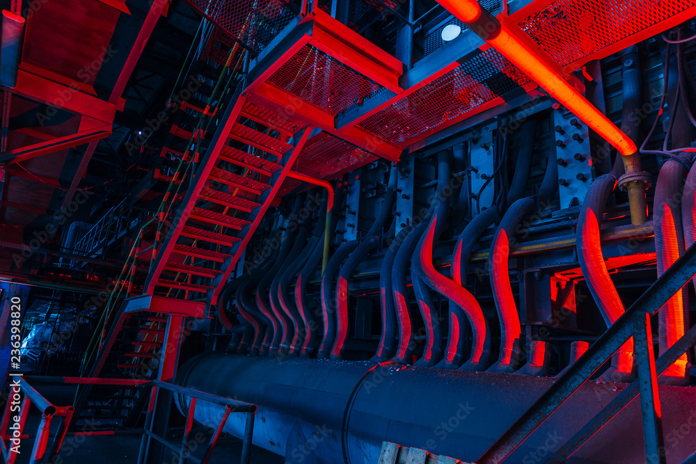 Inside of old abandoned factory. Rusty ruined industrial pipeline ...