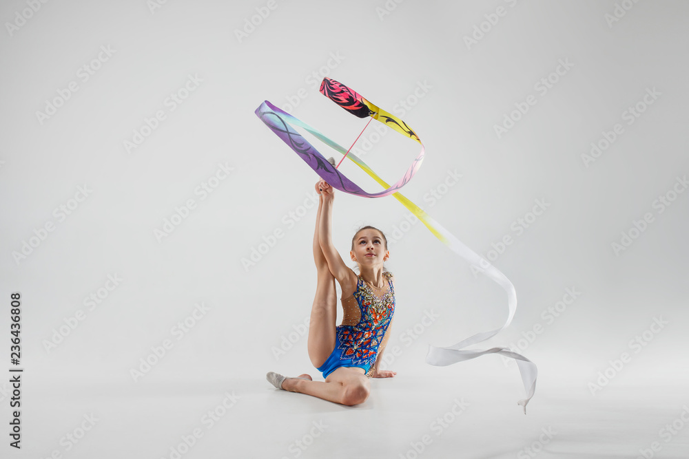 The portrait of beautiful young brunette woman gymnast training ...