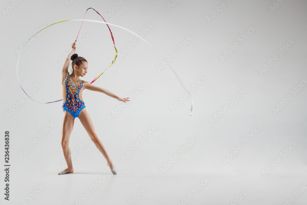 The portrait of beautiful young brunette woman gymnast training ...