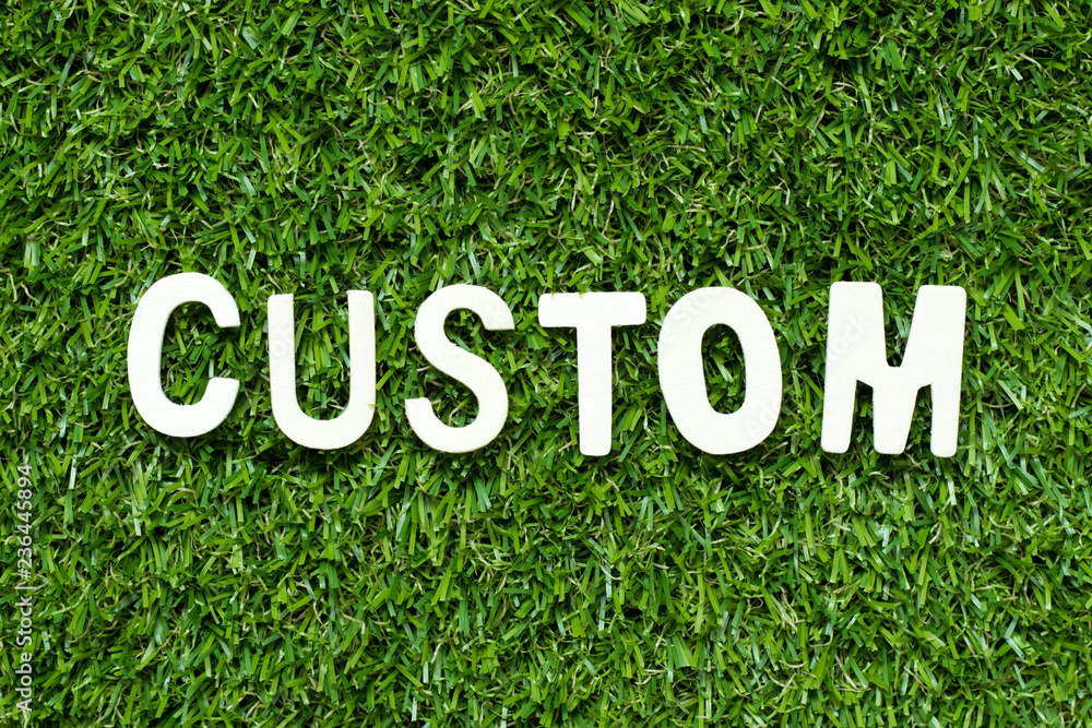 Alphabet letter in word custom on artificial green grass background ...