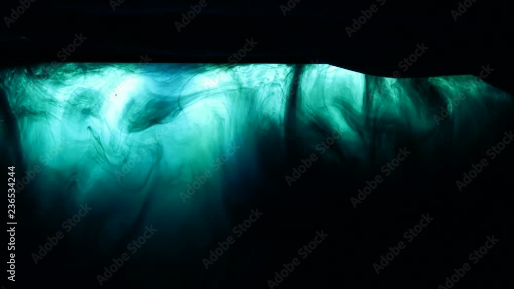 Vidéo Stock colored ink is injected into clear water, an artificial ...