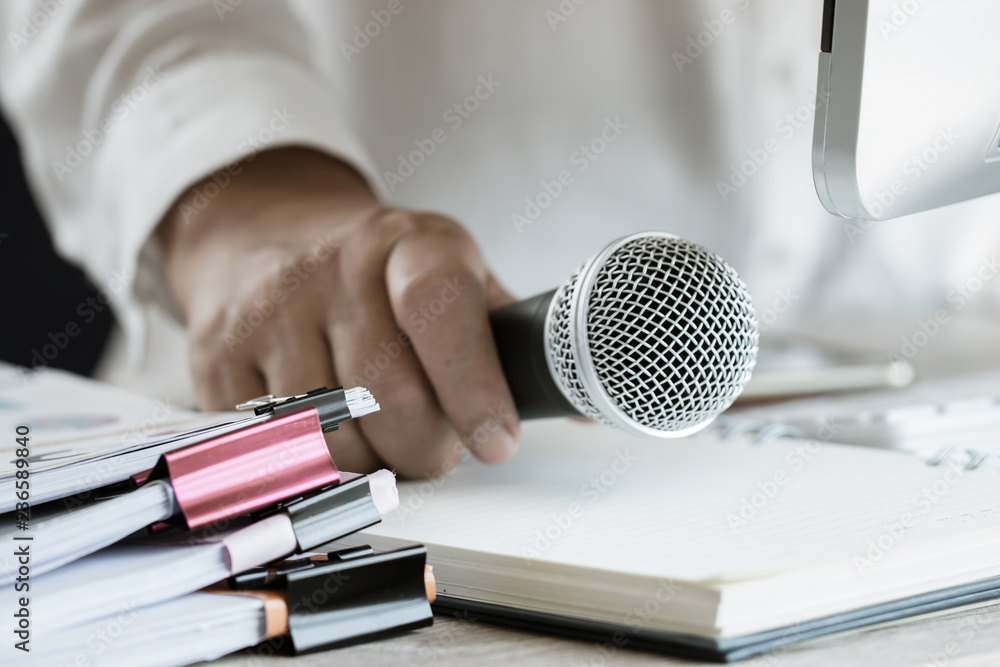 Teacher / speaker hold Microphone with paper document at seminar for ...