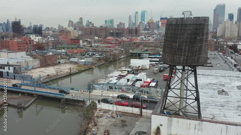alt flying counter clockwise around rooftop watertower overlooking Brooklyn's Gowanus Canal ...