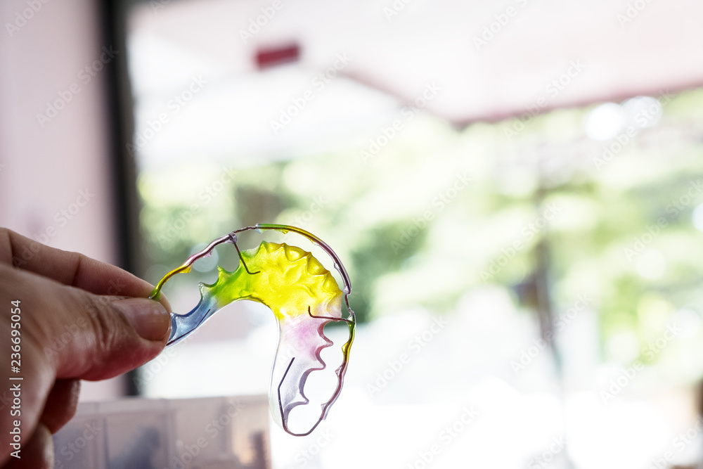 Dental retainer orthodontic appliance on the colour background. Stock ...